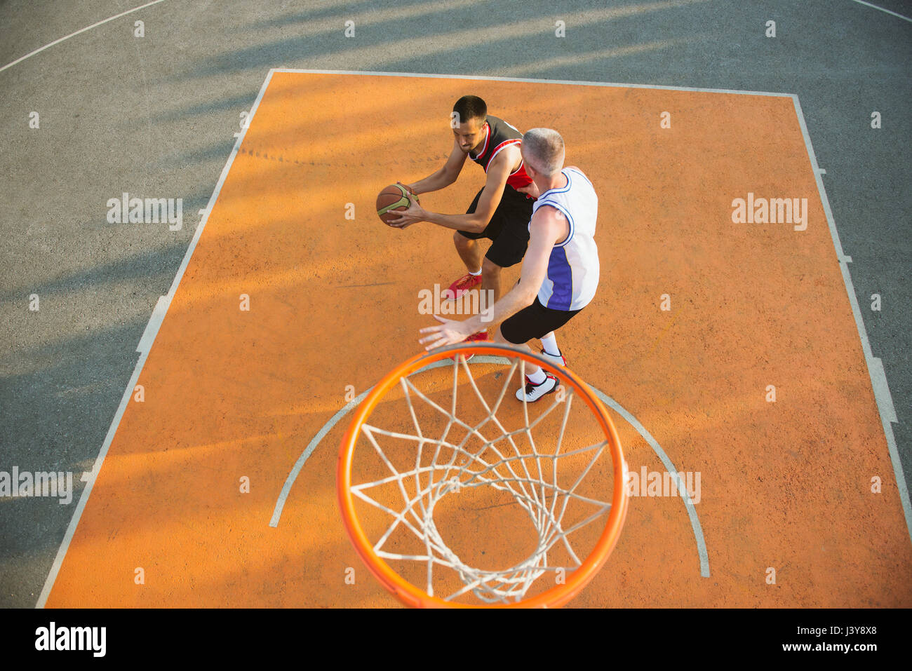 Two basketball players on the court outdoor Stock Photo - Alamy