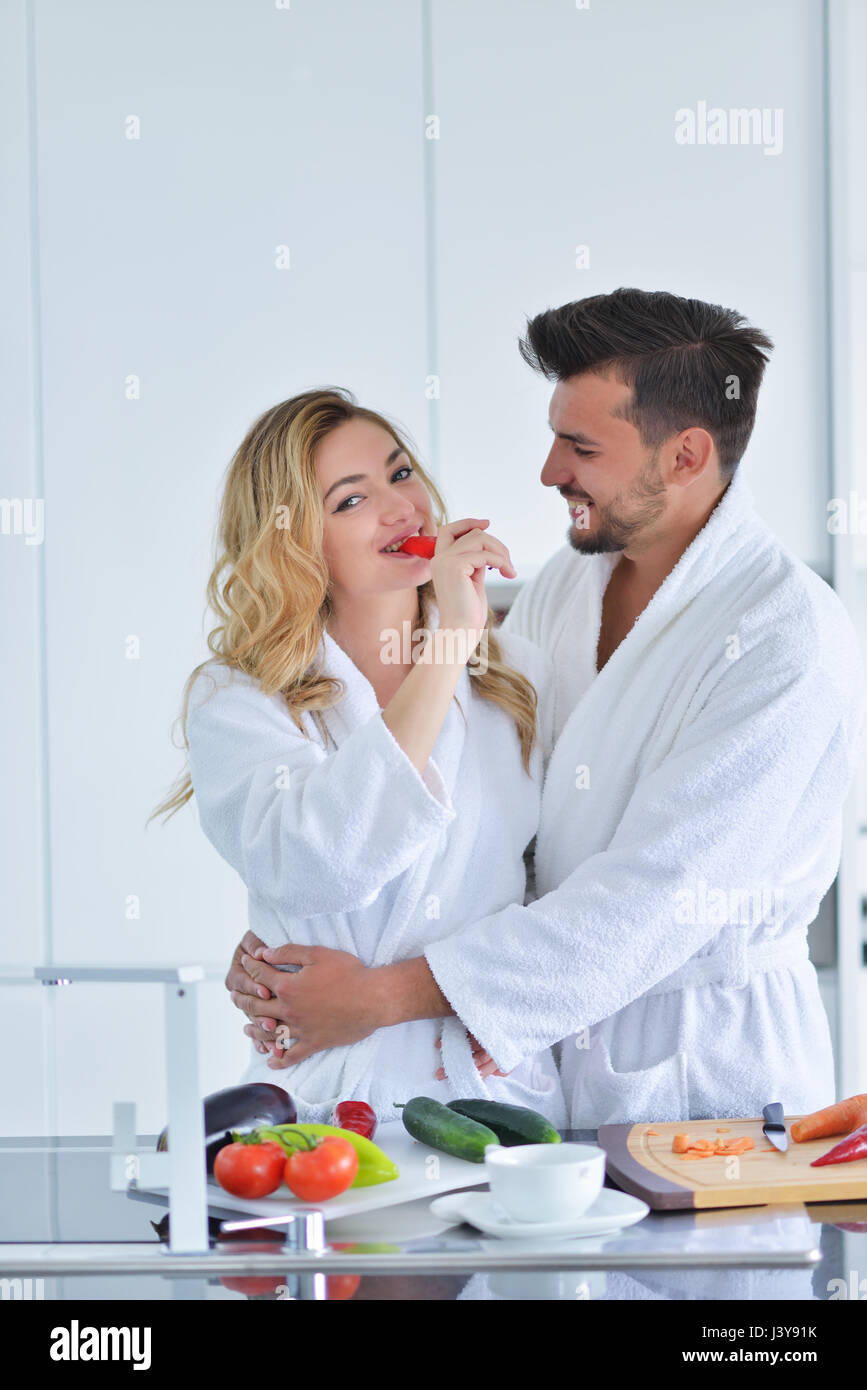 Happy couple cooking breakfast together in the kitchen Stock Photo - Alamy