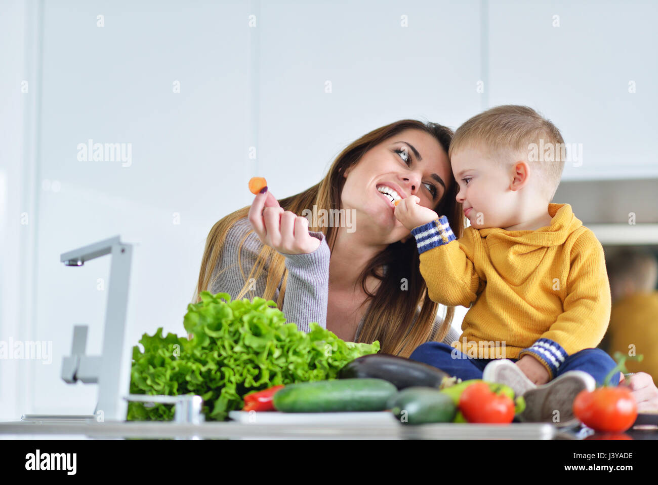 Mother and child preparing lunch from fresh veggies Stock Photo - Alamy