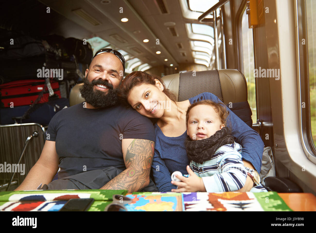 Modern young family travel in train. Smiling happy family on journey ...