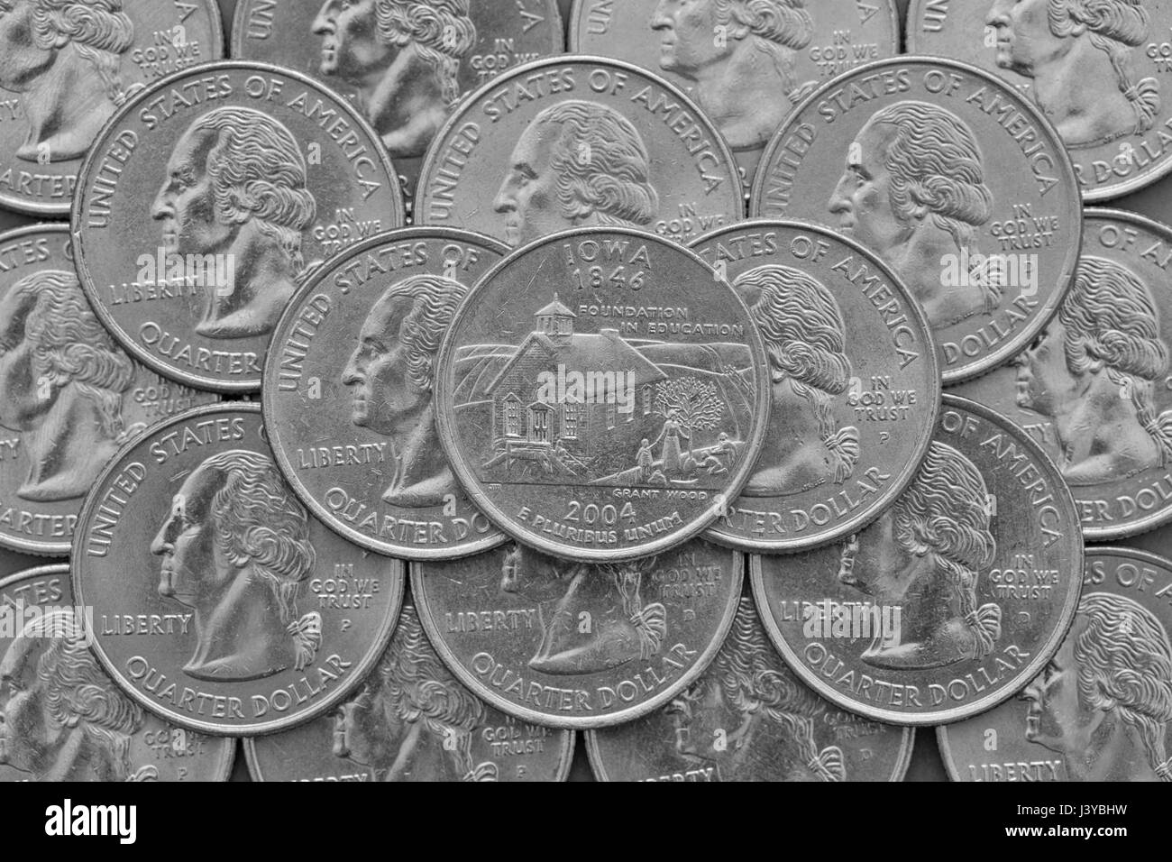Iowa State and coins of USA. Pile of the US quarter coins with George ...