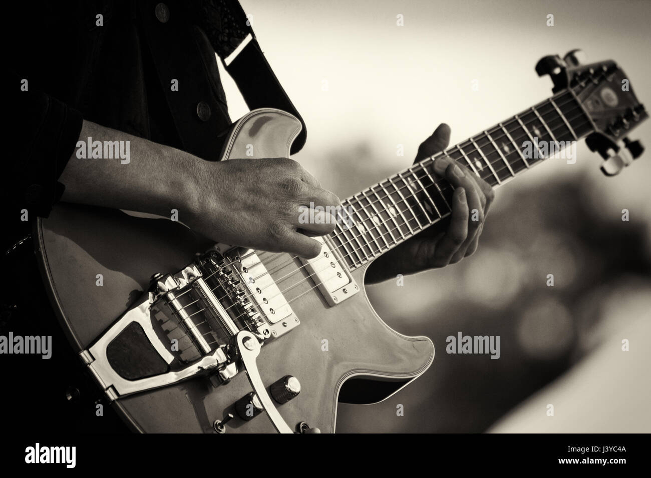 Close up of man playing a rock guitar Stock Photo - Alamy