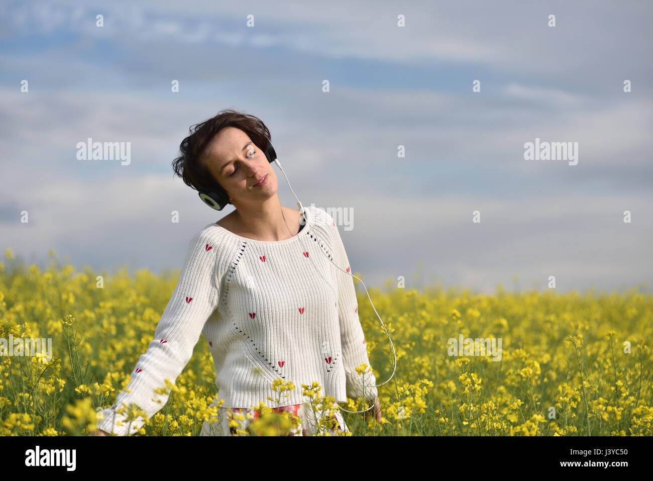 Portrait of happy smiling girl feeling free with music. Caucasian girl ...