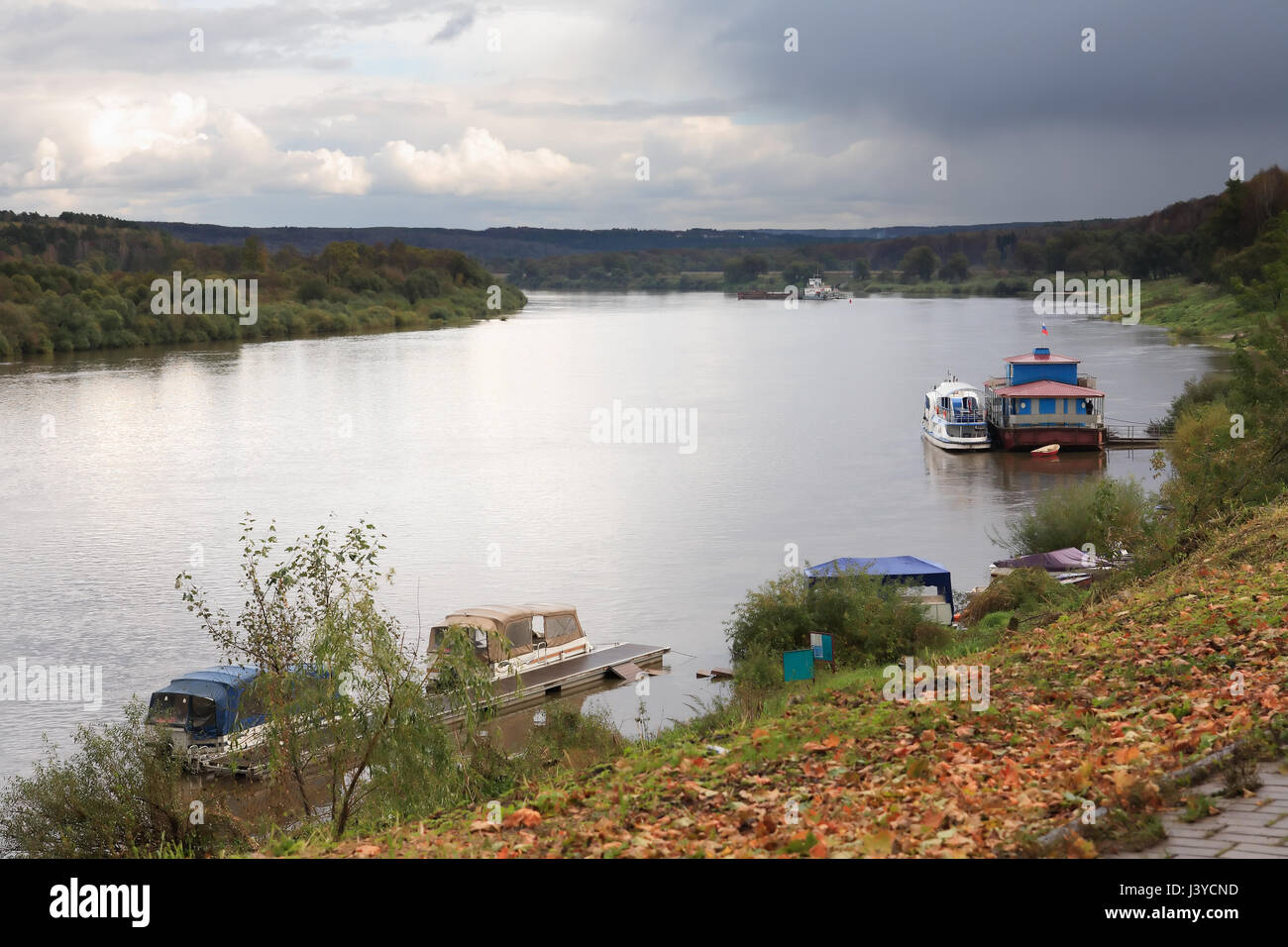 Autumn landscape. Nice view of river with floating pier under gloomy ...