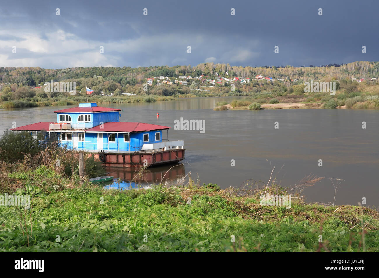 Autumn landscape. Nice view of river with floating pier under gloomy ...