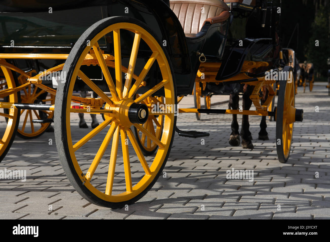 Closeup of nice vintage coach with big yellow wheel Stock Photo - Alamy