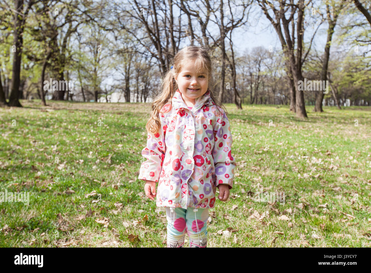 Spring Portrait of happy little girl in nature Stock Photo - Alamy