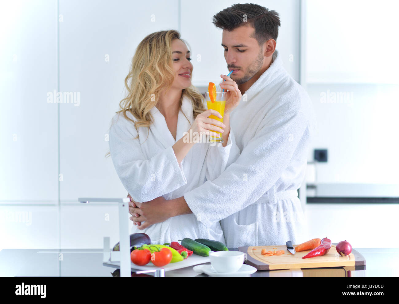 Happy couple cooking breakfast together in the kitchen Stock Photo - Alamy