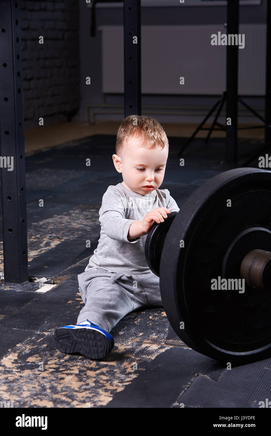 Cute little boy with dumbbells in the cross fit gym Stock Photo - Alamy