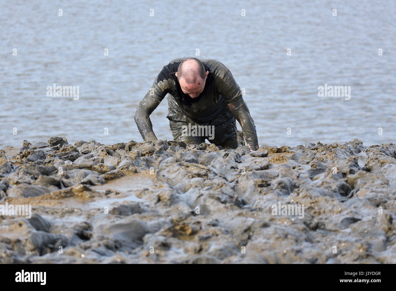 Mad Maldon Mud Race competitor covered in mud from racing through and ...