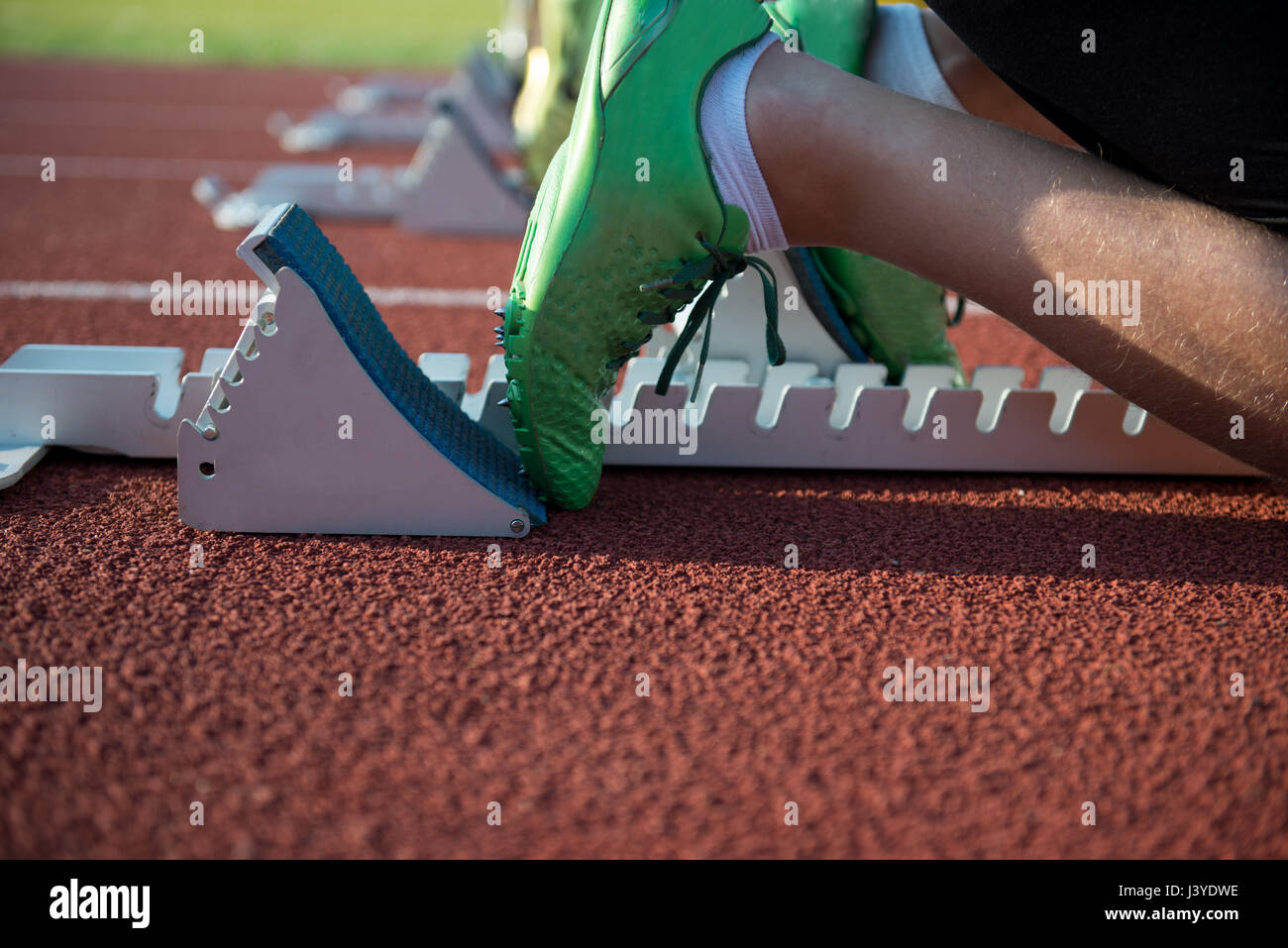 Runners preparing for race at starting blocks Stock Photo - Alamy