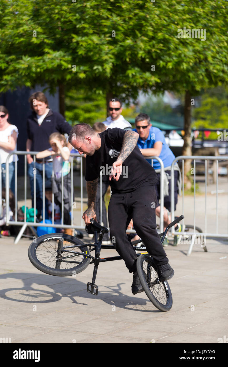A stunt cyclist riding a bike / cycle during an exhibition performing ...
