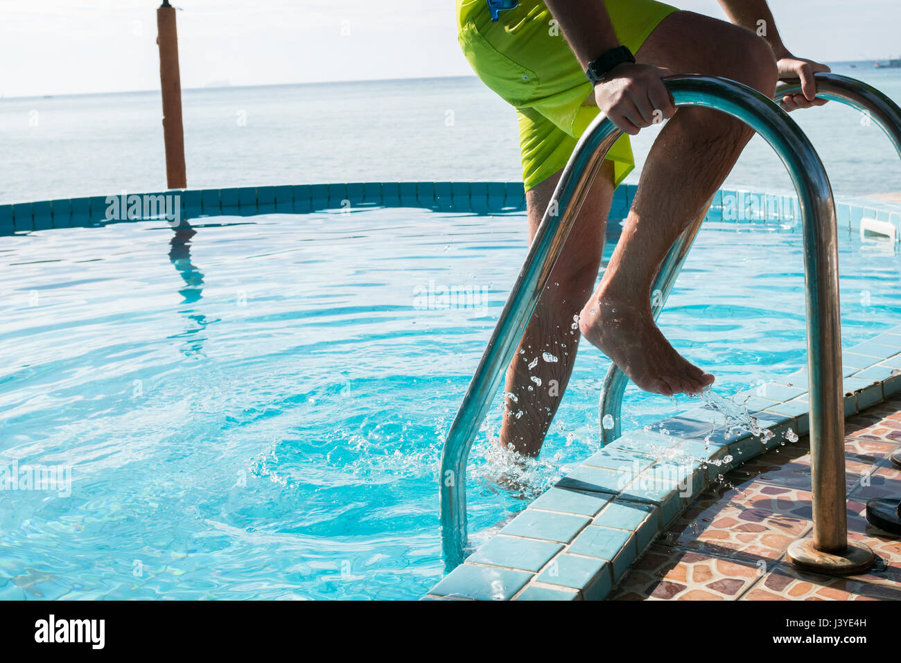 Guy comes out of pool Stock Photo - Alamy