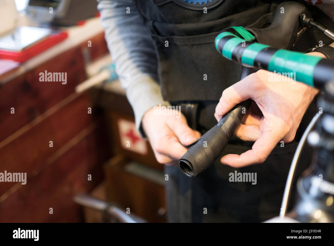Man fixing bicycle in garage Stock Photo - Alamy
