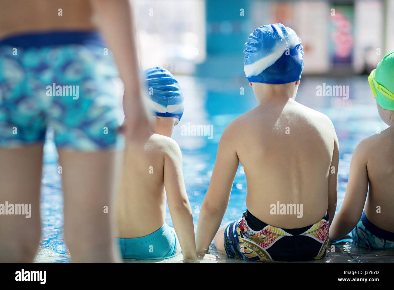 happy children kids group at swimming pool class learning to swim Stock ...