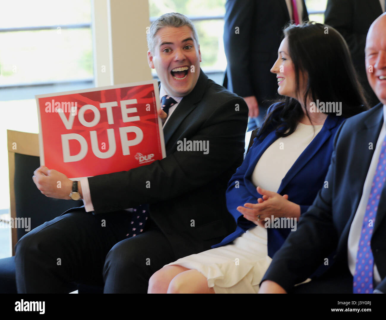 DUP Candidate for East Belfast Gavin Robinson holds an election poster ...