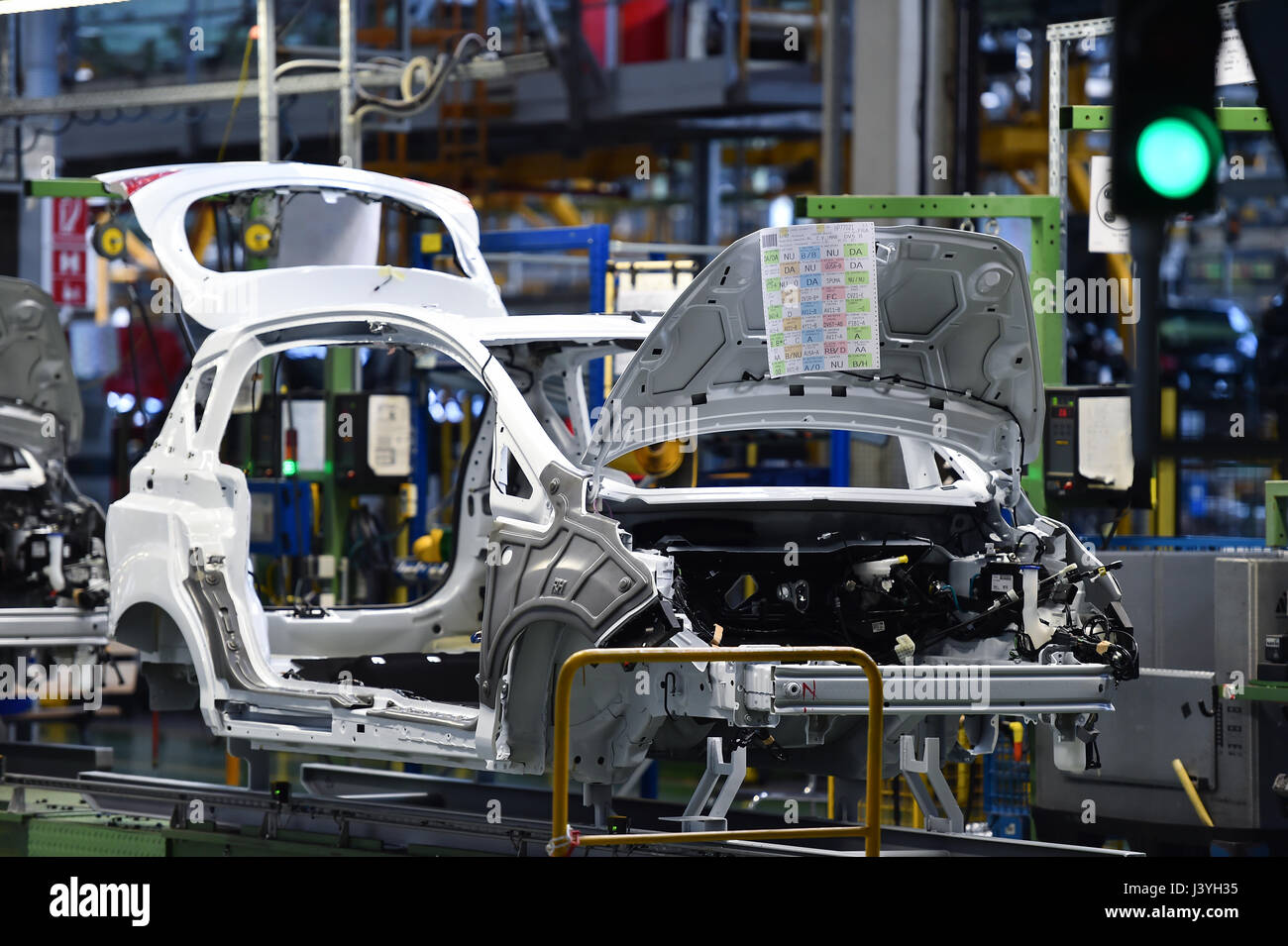 Car bodies on the production line inside automobile factory Stock Photo ...