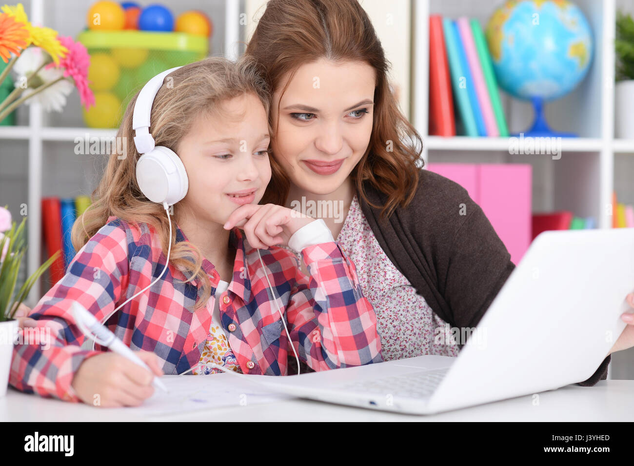 Mom and daughter doing lessons Stock Photo - Alamy