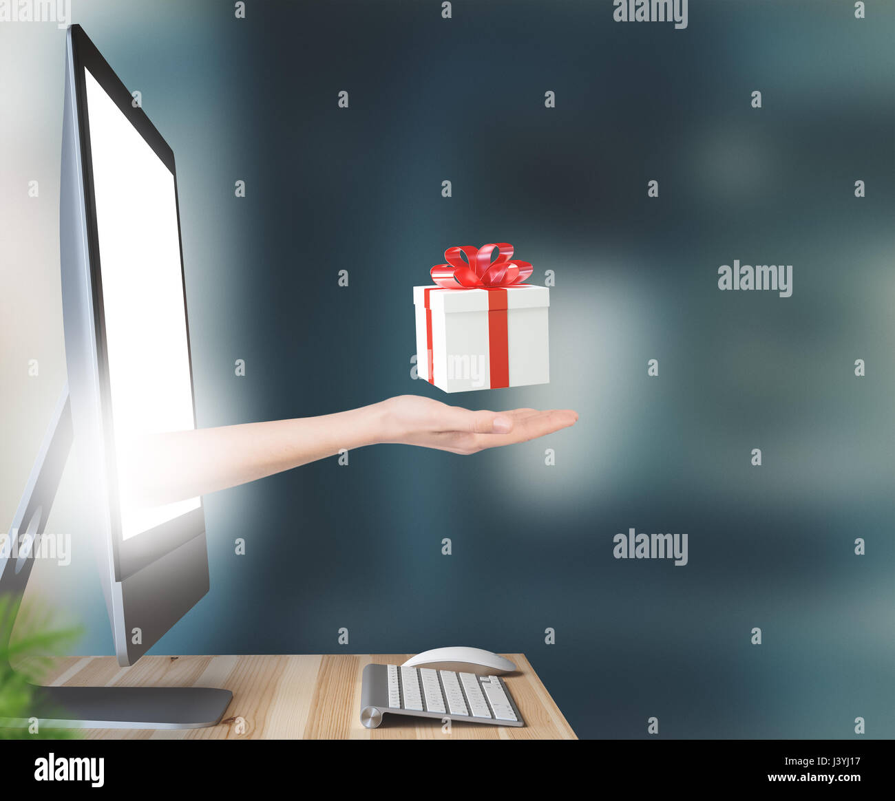 Hand with present or gift box comes outo of pc monitor Stock Photo - Alamy
