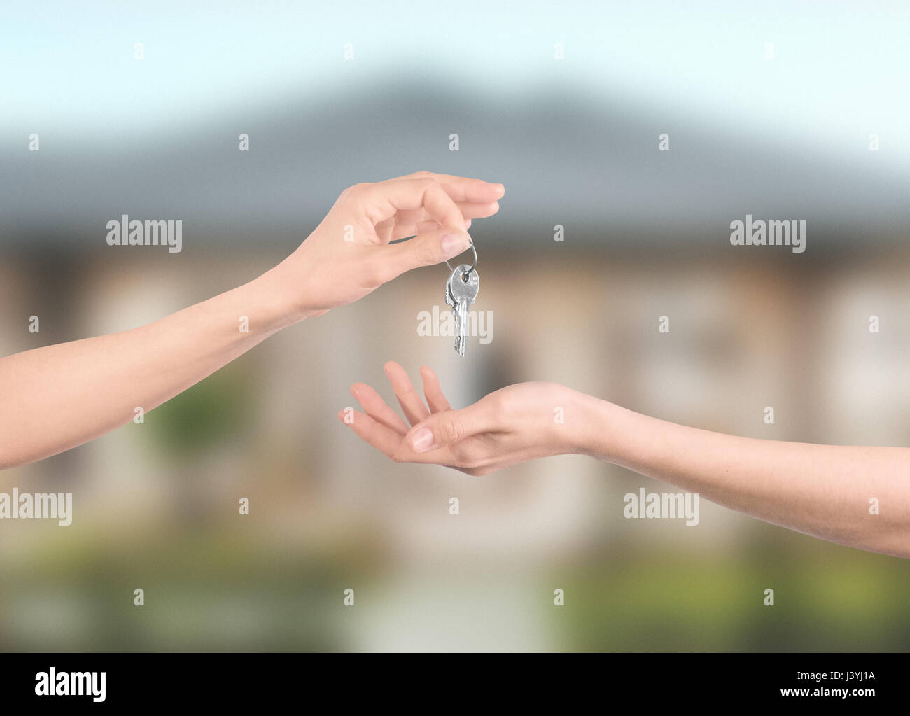 Hands and keys, give keys of new house Stock Photo - Alamy