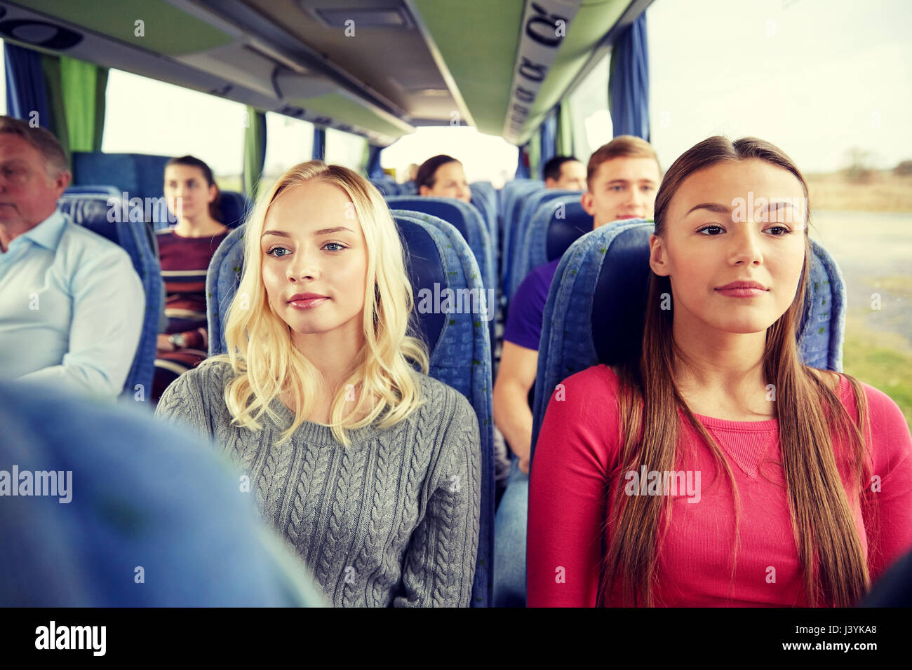 happy young women riding in travel bus Stock Photo - Alamy