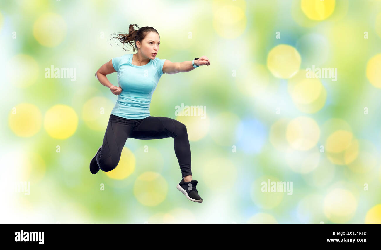 happy sporty young woman jumping in fighting pose Stock Photo - Alamy