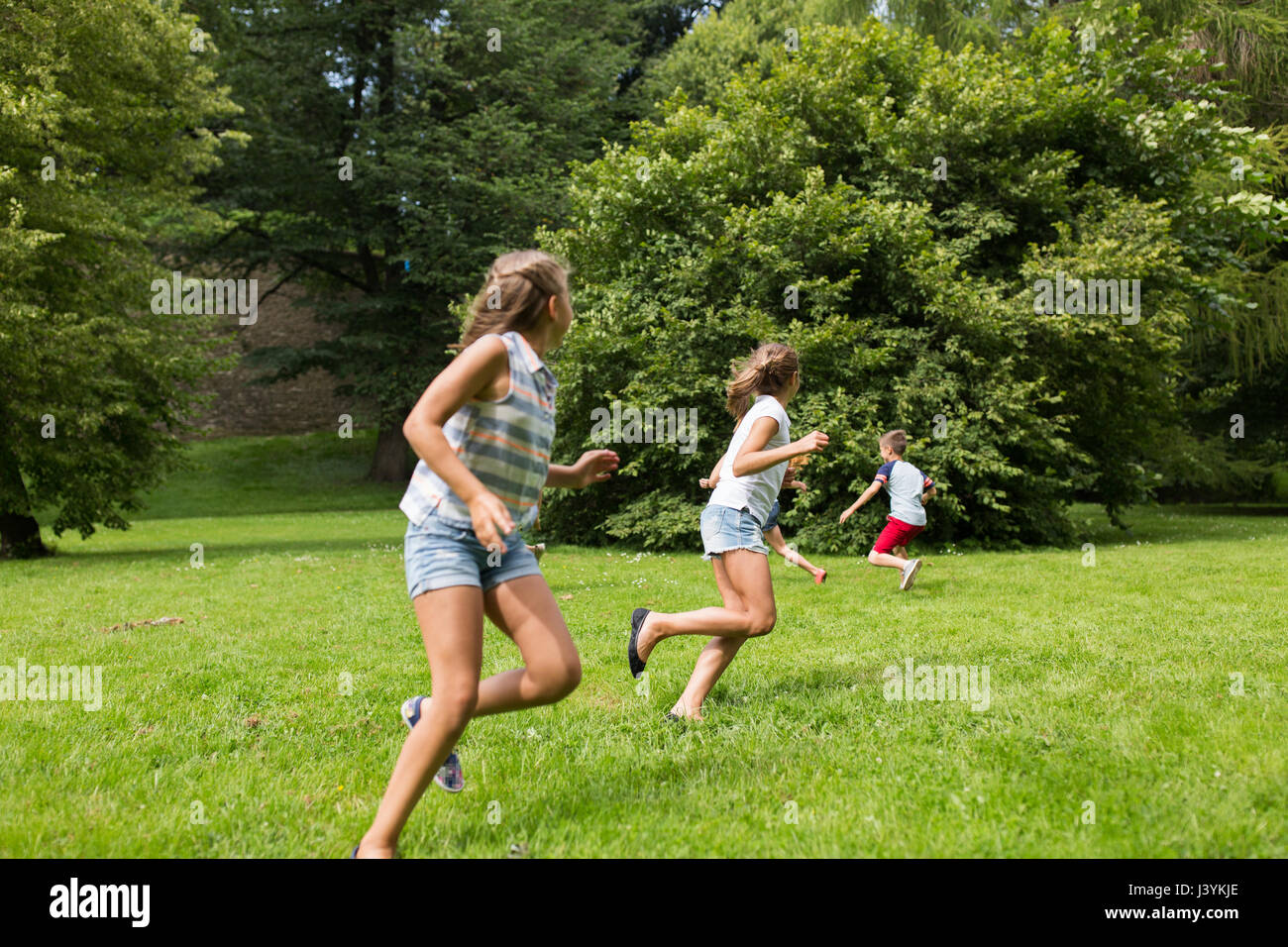 group of happy kids or friends playing outdoors Stock Photo - Alamy