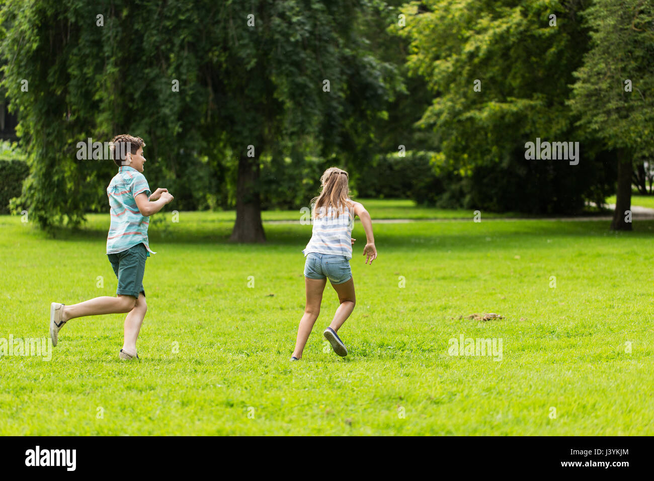 group of happy kids or friends playing outdoors Stock Photo - Alamy