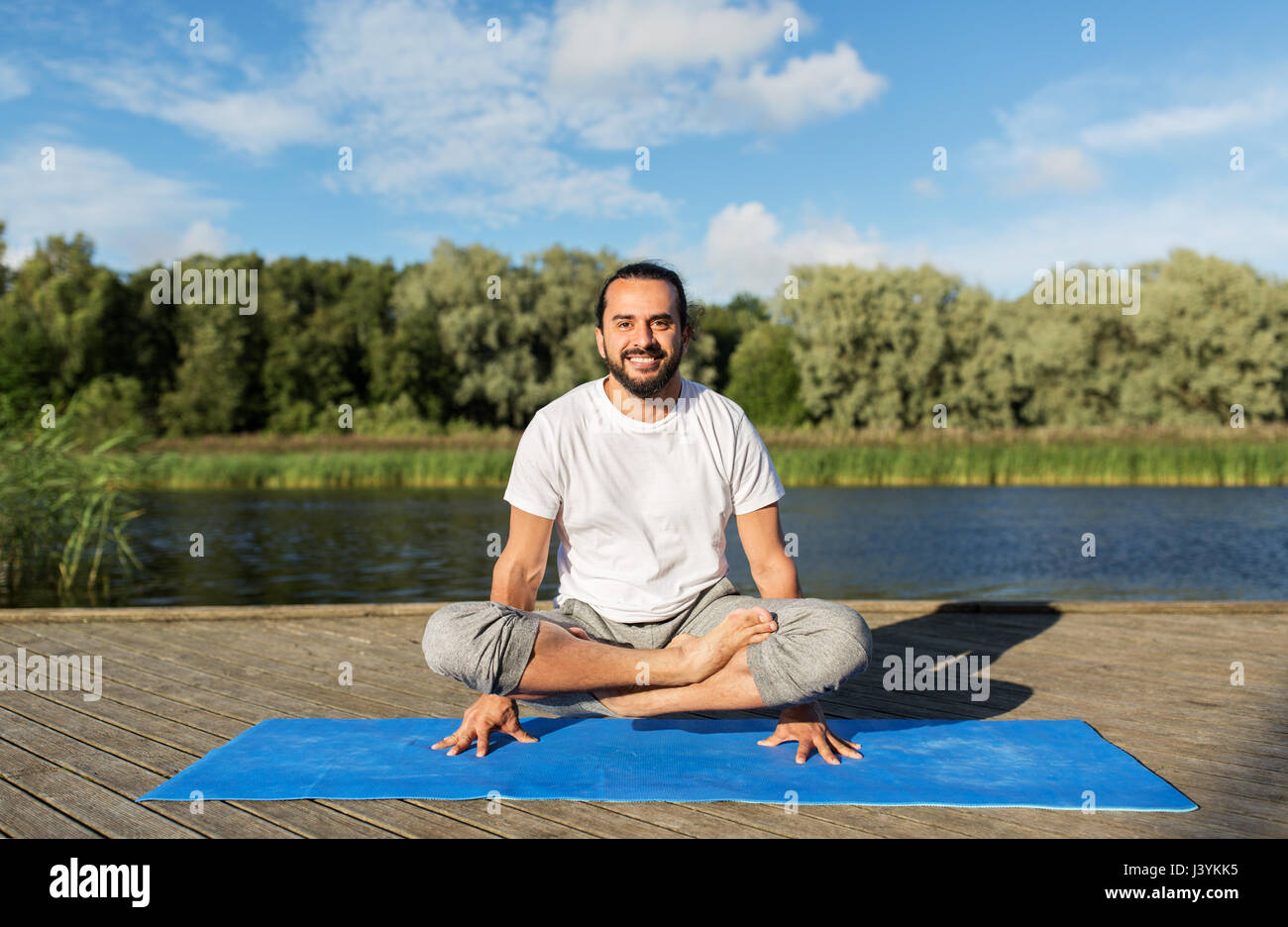 man making yoga in scale pose outdoors Stock Photo - Alamy