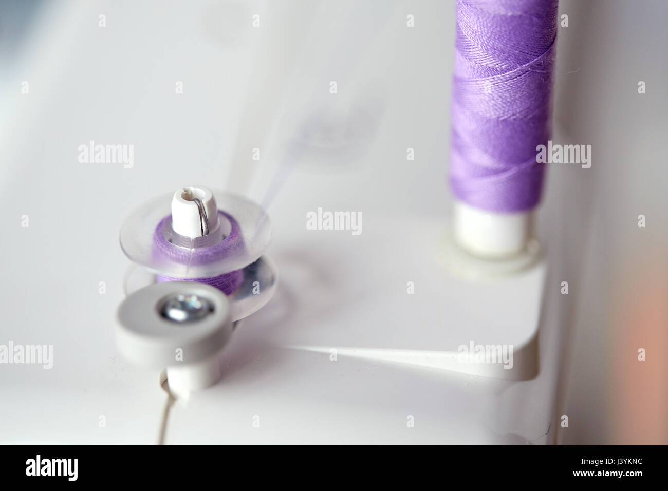 thread spools on sewing machine Stock Photo - Alamy