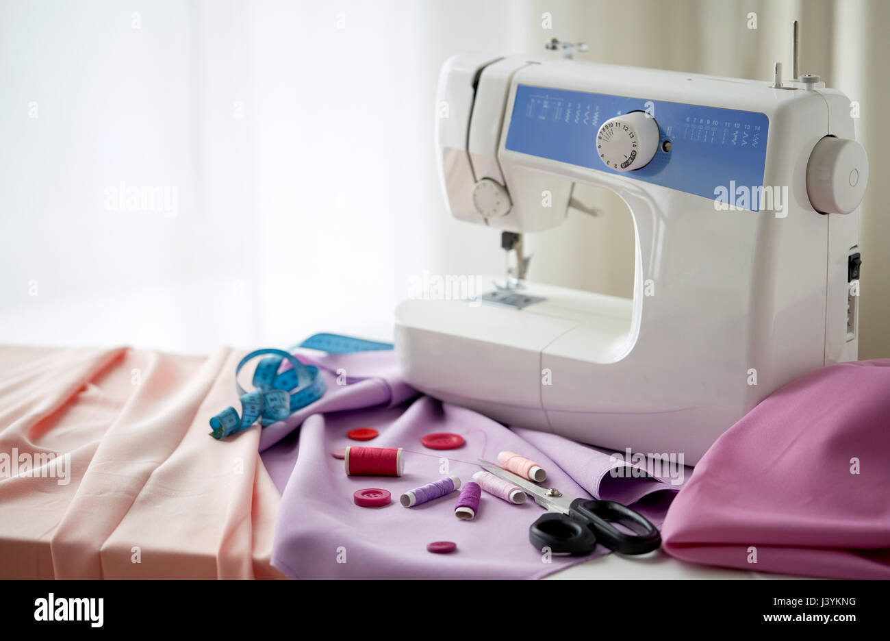 sewing machine, scissors, buttons and fabric Stock Photo - Alamy