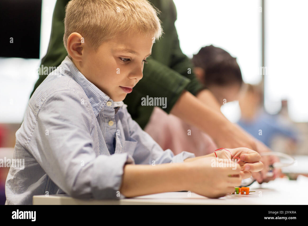 close up of boy building robot at robotics school Stock Photo - Alamy
