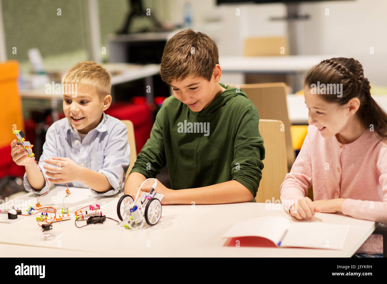 happy children building robots at robotics school Stock Photo - Alamy