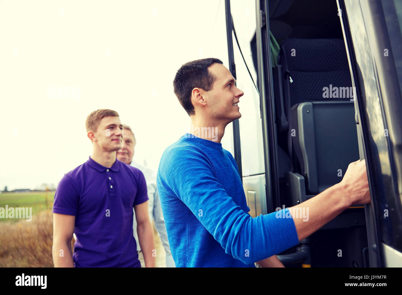 group of happy male passengers boarding travel bus Stock Photo - Alamy