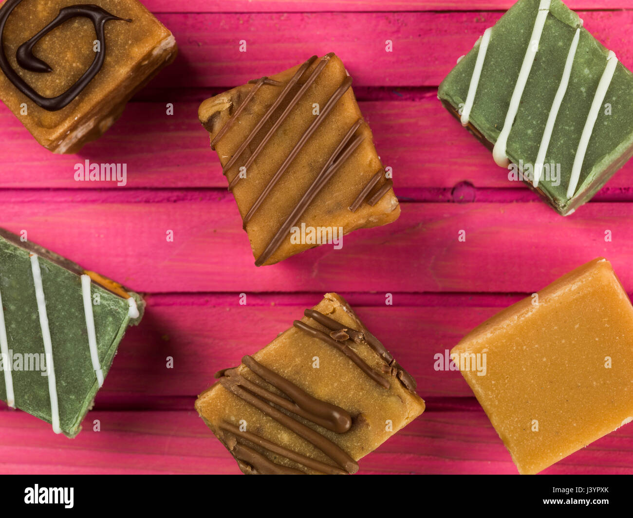 Selection of Fudge Sweets or Chocolates Confectionery Against a Pink ...