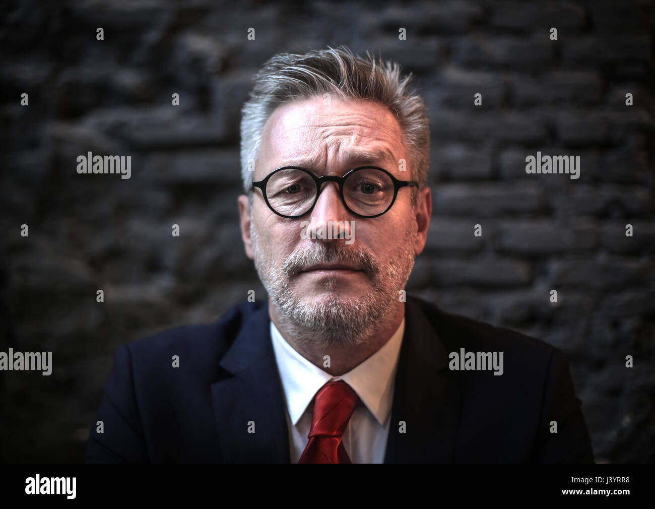 Portrait of an handsome man doing a grimace Stock Photo - Alamy