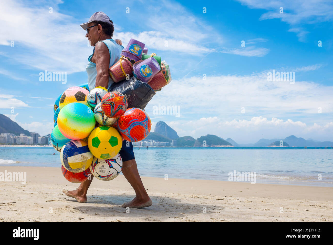 RIO DE JANEIRO - FEBRUARY 10, 2017: Brazilian beach vendor walks along ...