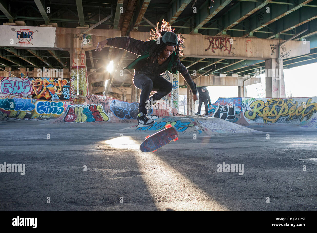 A young man skateboarding Stock Photo - Alamy