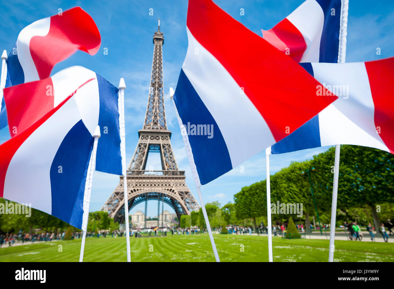 French tricolour flags flying in blue sky on a bright spring day in ...