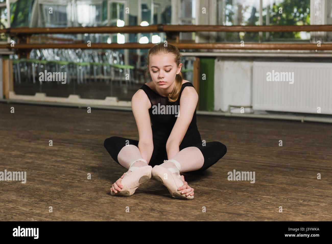 Young beautiful ballerina warming up in ballet class. Beautiful ...
