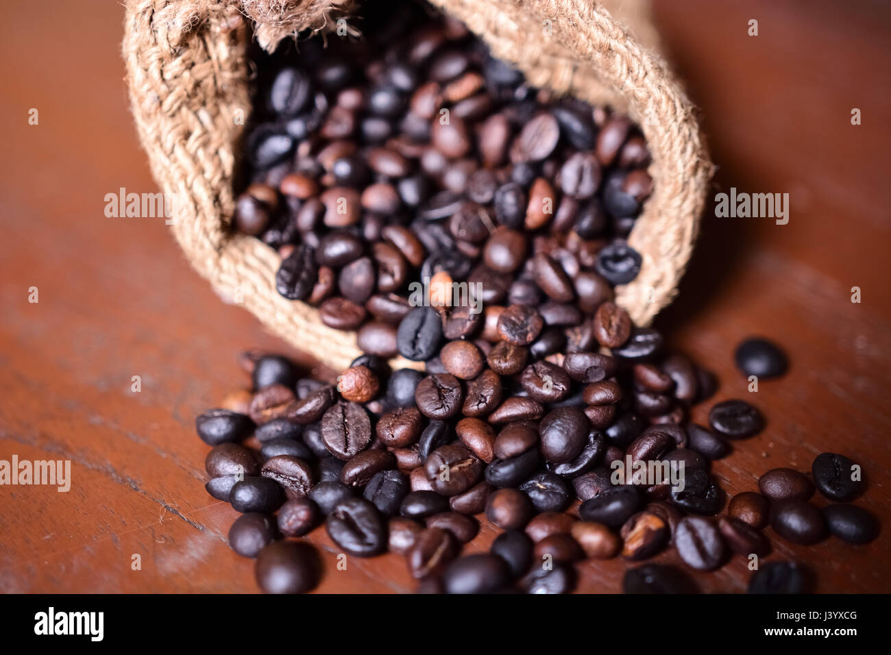 Pouring coffee beans Stock Photo - Alamy