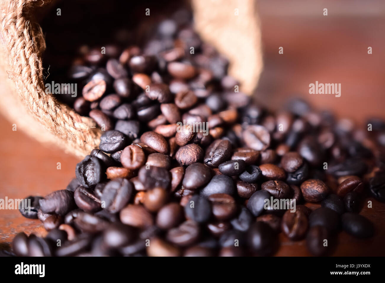 Pouring coffee beans Stock Photo - Alamy