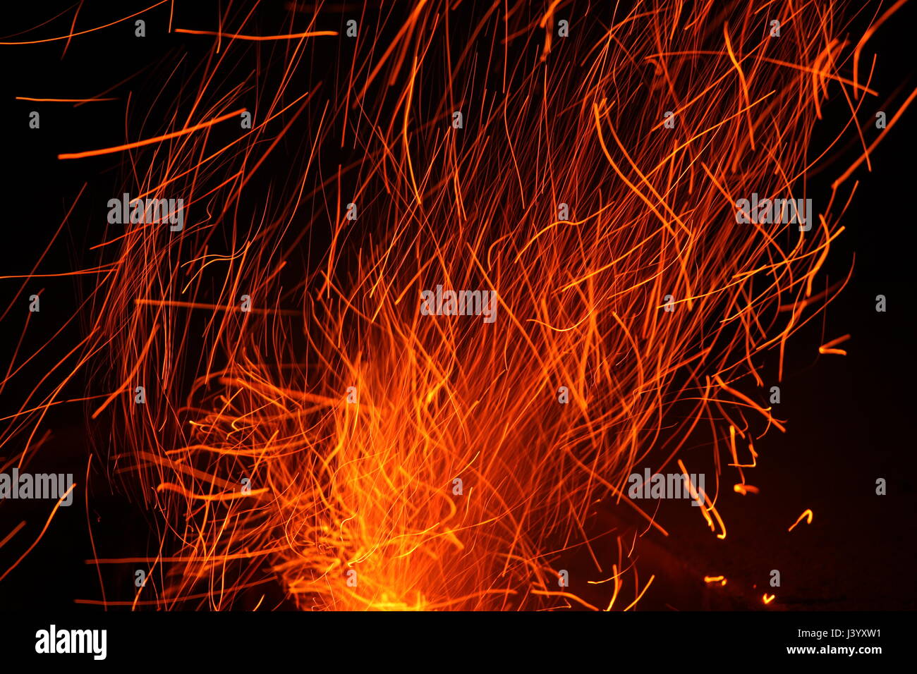 Red hot sparks fly up from the wood being burnt on a bonfire Stock ...