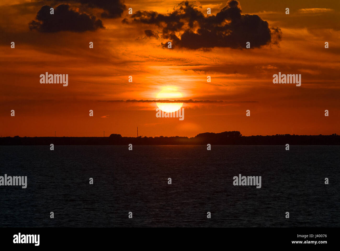 Sunset sunrise red orange yellow sky sun clouds Stock Photo - Alamy