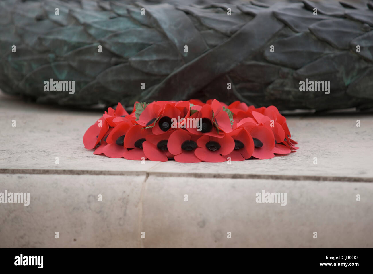 A remembrance day Poppy Wreath placed next to the memorial at sculpture ...
