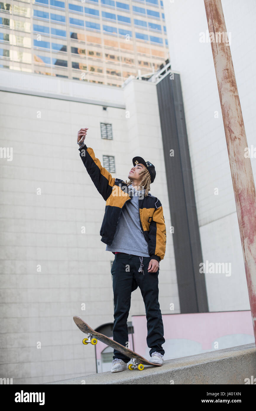 Young man skateboarding Stock Photo - Alamy