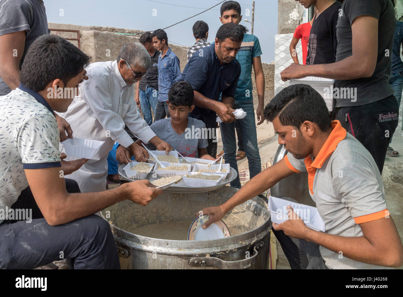 Men Serving Halim -local porridge- in plastic containers to be brought ...