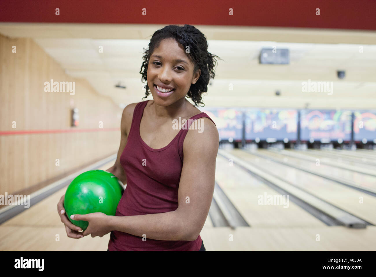 A young woman with a bowling ball Stock Photo - Alamy