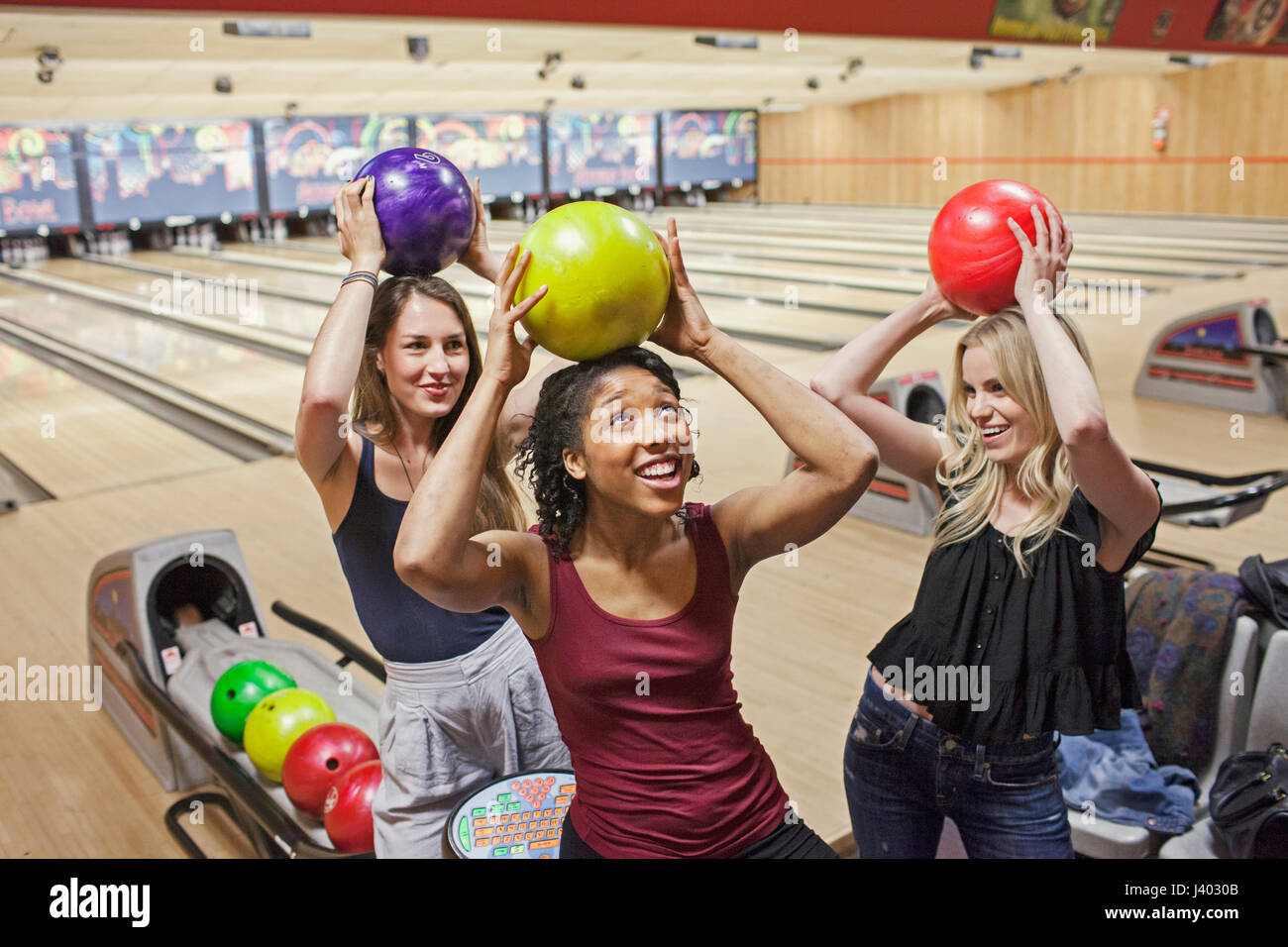 A young woman with a bowling ball Stock Photo - Alamy