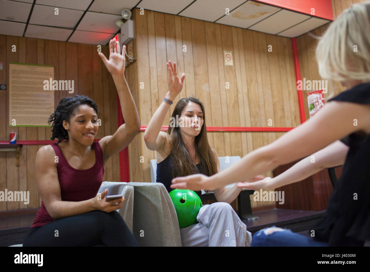 Three women at a bowling alley hi-res stock photography and images - Alamy